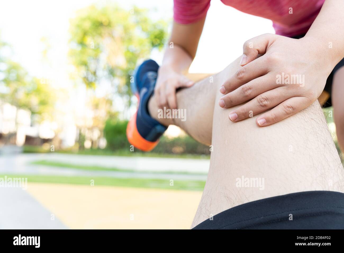 Female hand grab male leg to stretch after exercise injury Stock Photo ...
