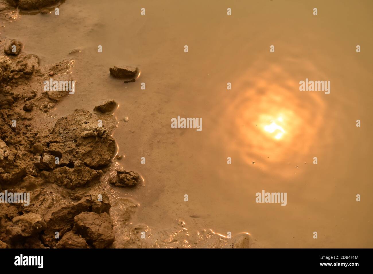 Reflection of the sun in muddy water during the Cameron Peak fire in ...