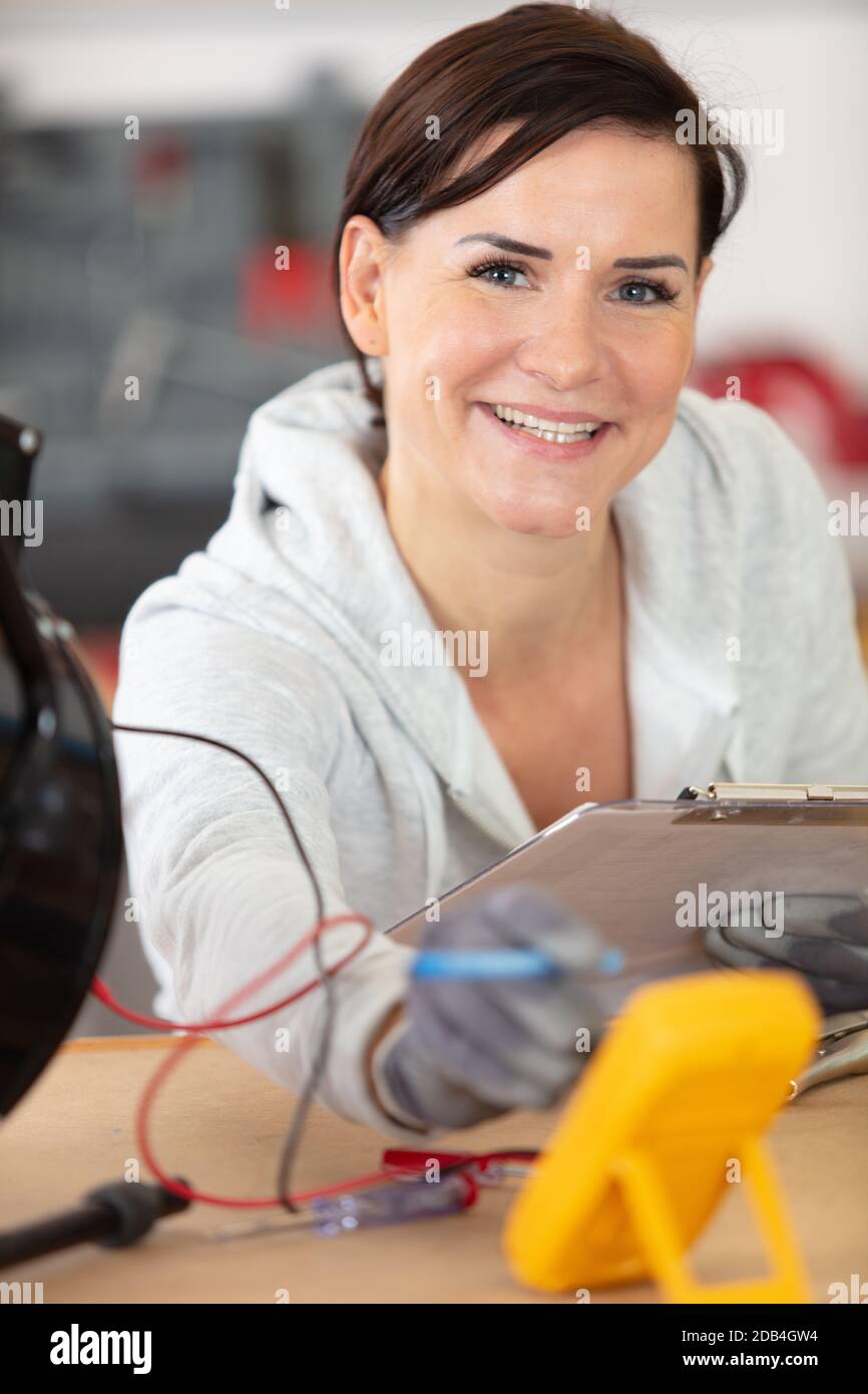 female electrician testing charge to spotlight Stock Photo - Alamy
