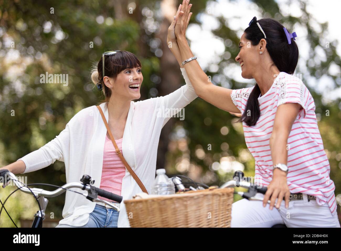 two friends on bikes outdoors smiling Stock Photo - Alamy