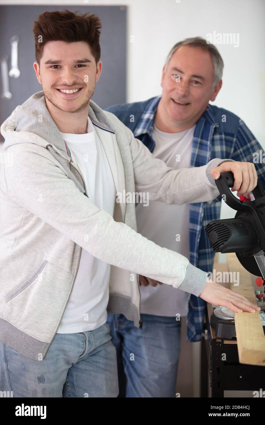 old carpenter with apprentice in training period Stock Photo - Alamy