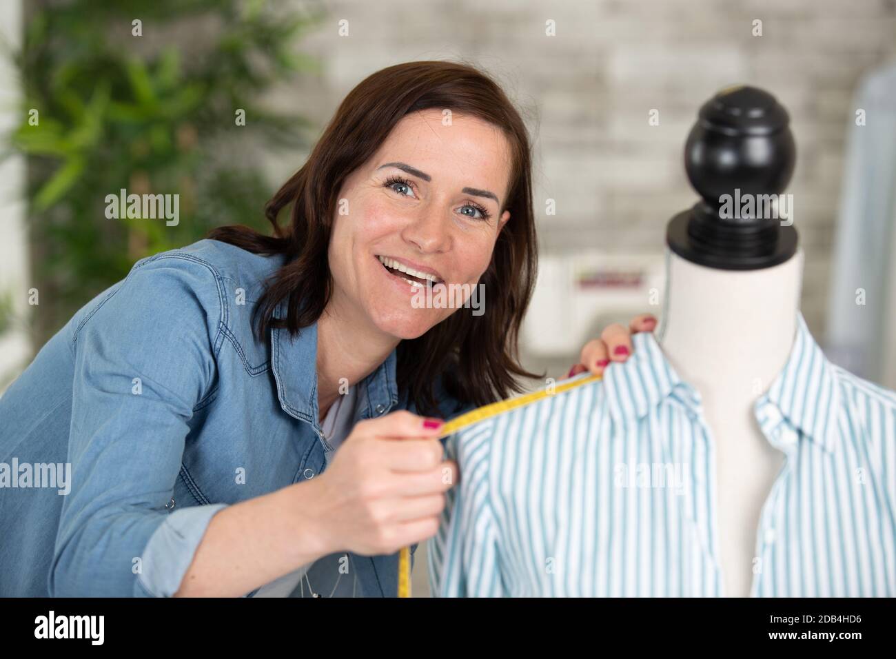 seamstress measuring shoulder on a mannequin Stock Photo - Alamy