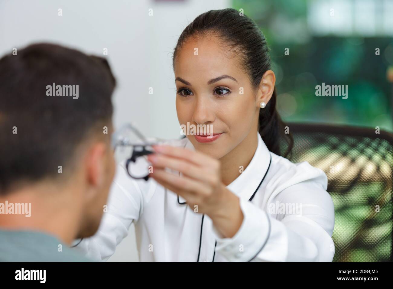 woman putting glasses on a man Stock Photo - Alamy