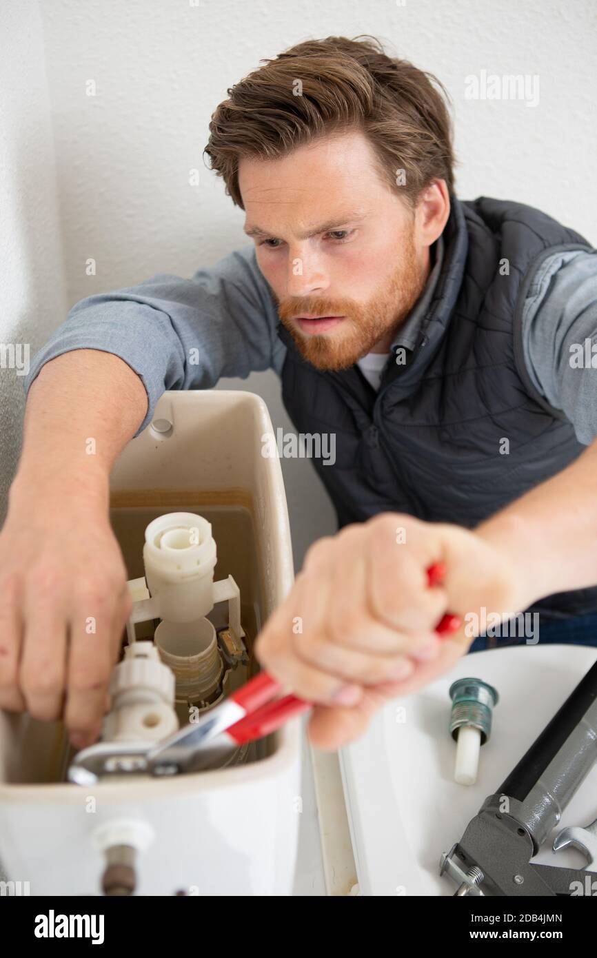 Plumber repairing toilet hi-res stock photography and images - Alamy