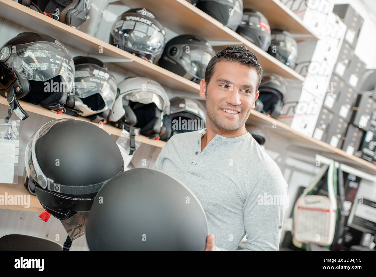 Man holding two crash helmets Stock Photo - Alamy