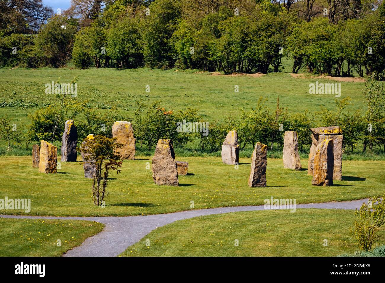 Ancient megalithic stone formation or monument on green field with ...