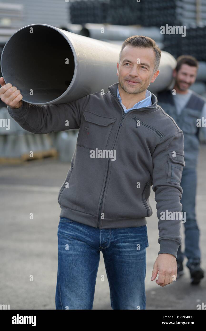 Construction workers carrying pipe hi-res stock photography and images ...