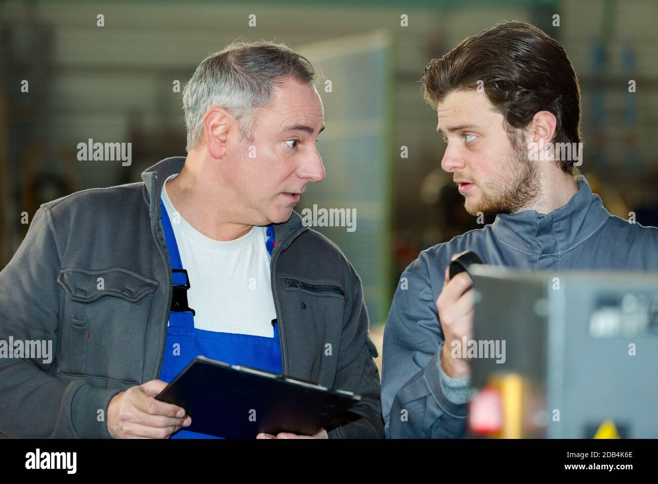 male manual workers manufacturing sheet metal at factory Stock Photo ...