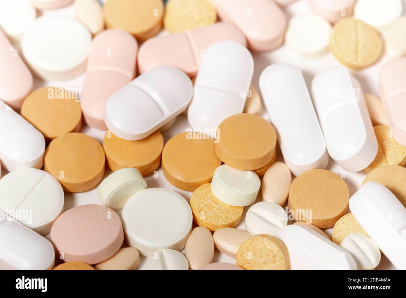Assorted mix of pills over a white background Stock Photo - Alamy
