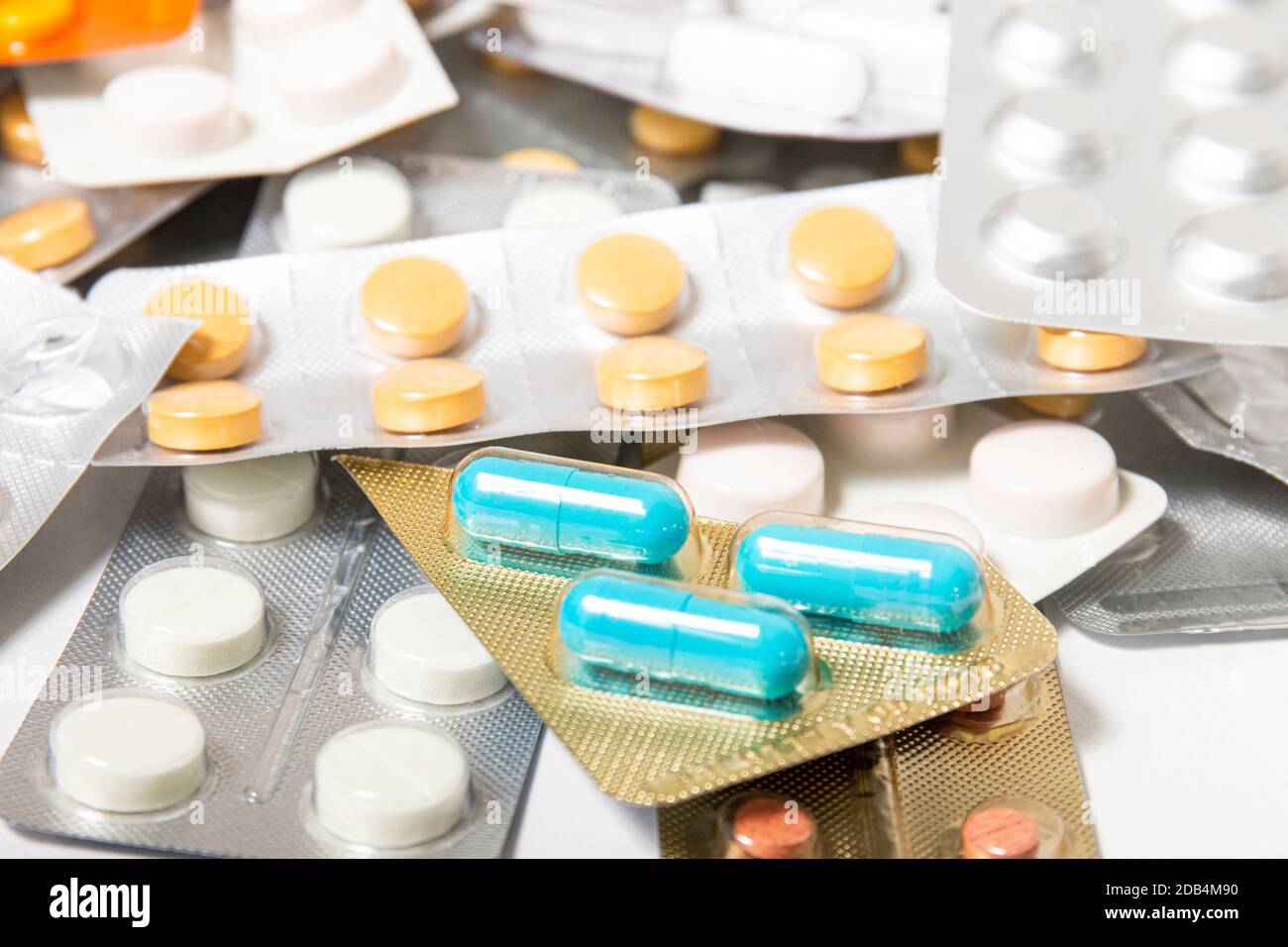 Assorted mix of pills over a white background Stock Photo - Alamy
