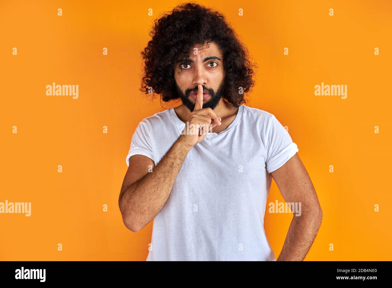 indian arabic male asking to be quiet with finger on lips, silence and ...