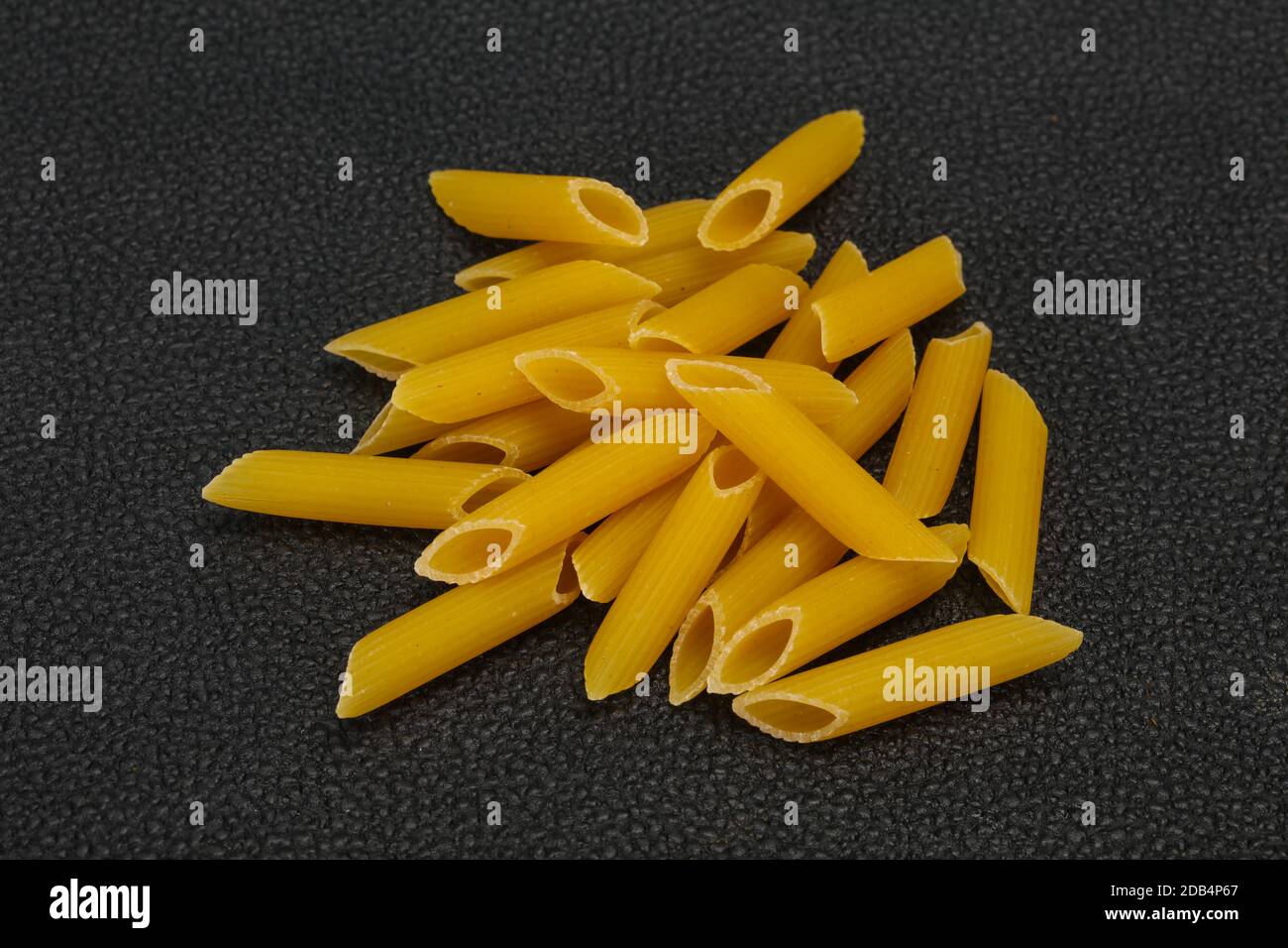 Raw penne pasta ready for bowl Stock Photo - Alamy