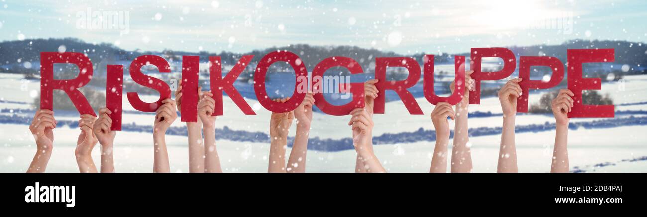 People Hands Holding Red German Word Risikogruppe Means High-Risk Group ...
