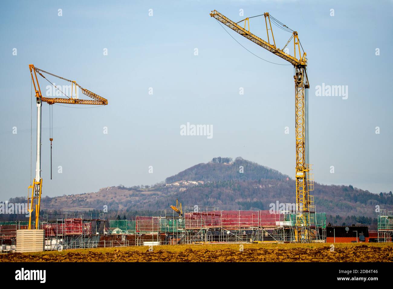 construction field in winter with cranes and famous German hill Stock ...