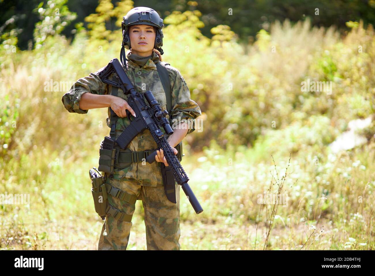strong brave female army soldier with rifle machine gun standing in the ...
