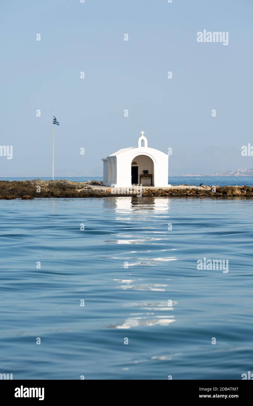 View over the water to Agios Nikolaos Chapel in the village of ...