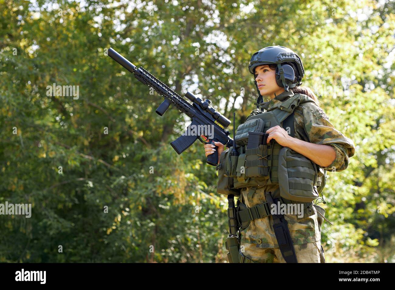 strong brave female army soldier with rifle machine gun standing in the ...