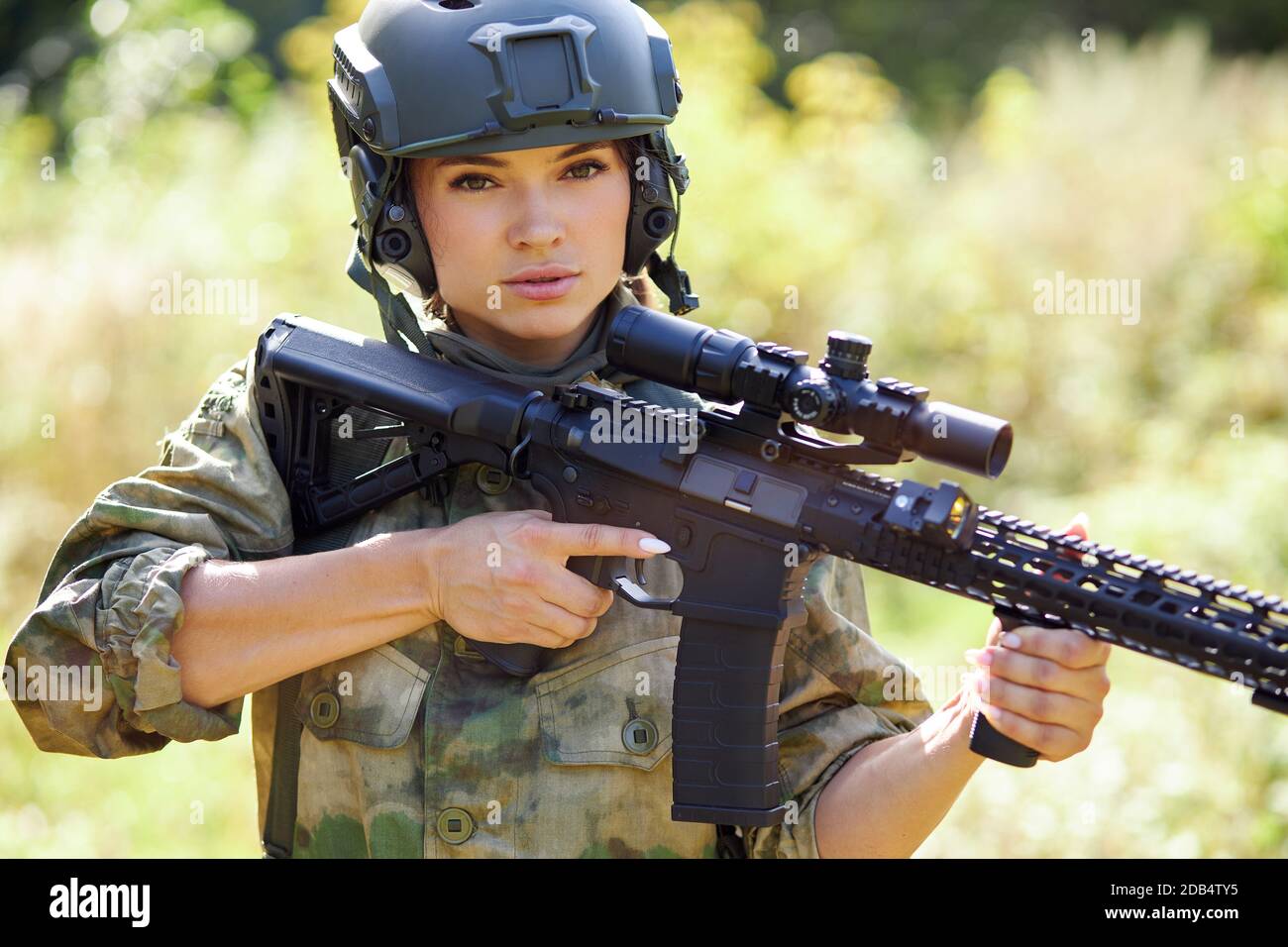 brave caucasian woman is engaged in hunting weapon gun or rifle ...