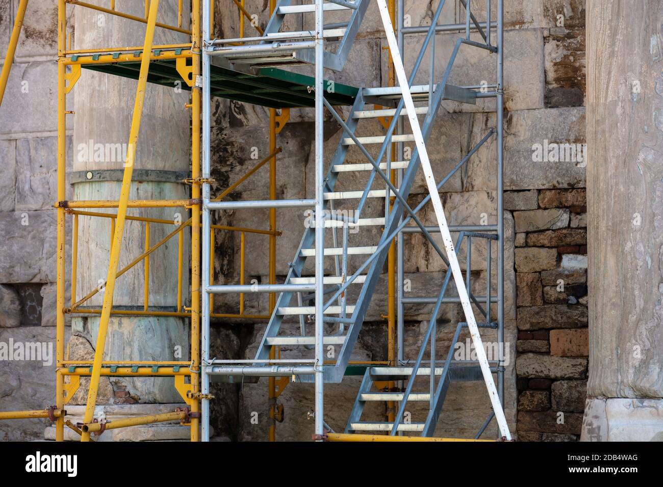 Metal scaffold with ladders installed outside aged building during ...