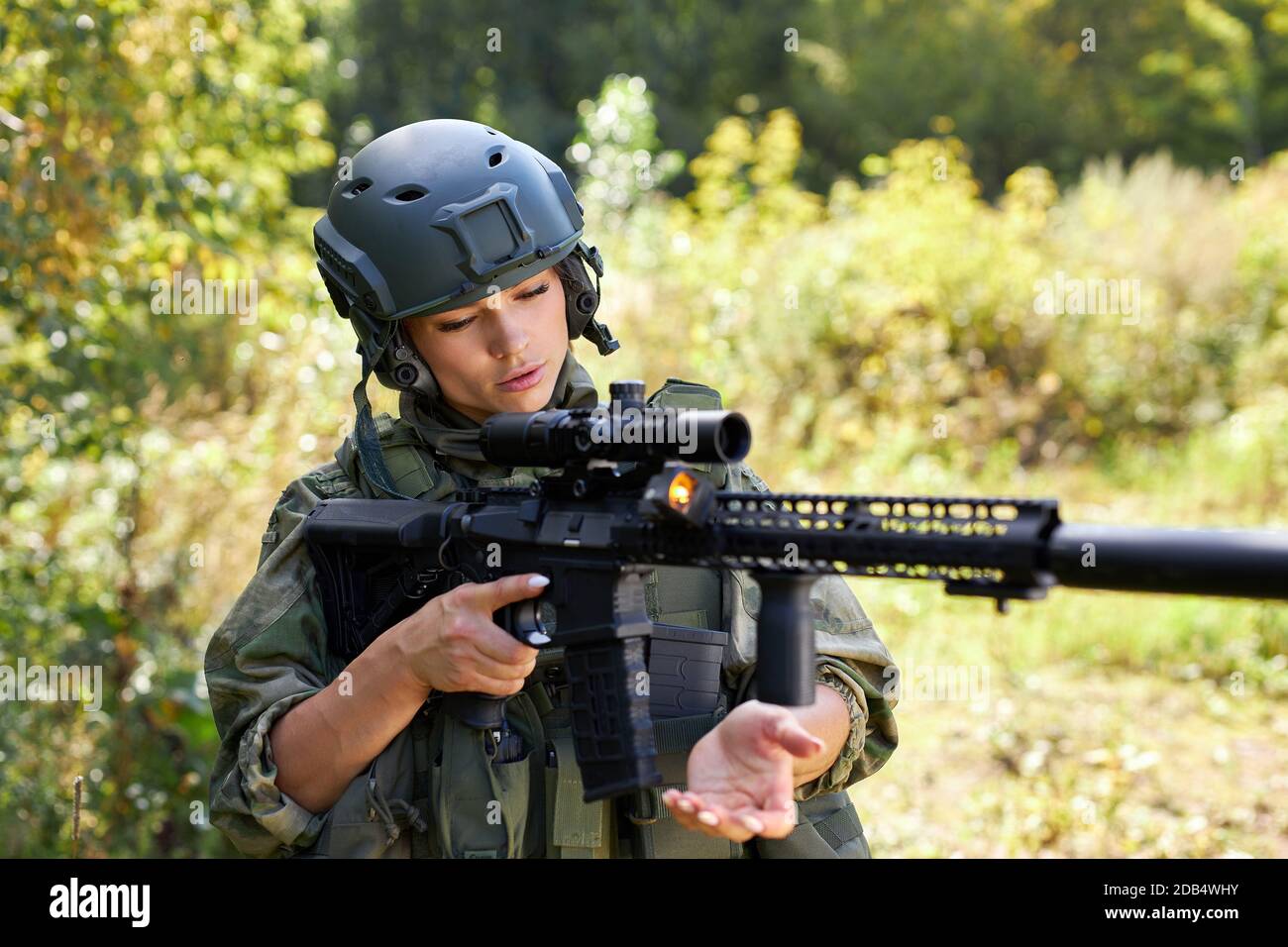 brave caucasian woman is engaged in hunting weapon gun or rifle ...