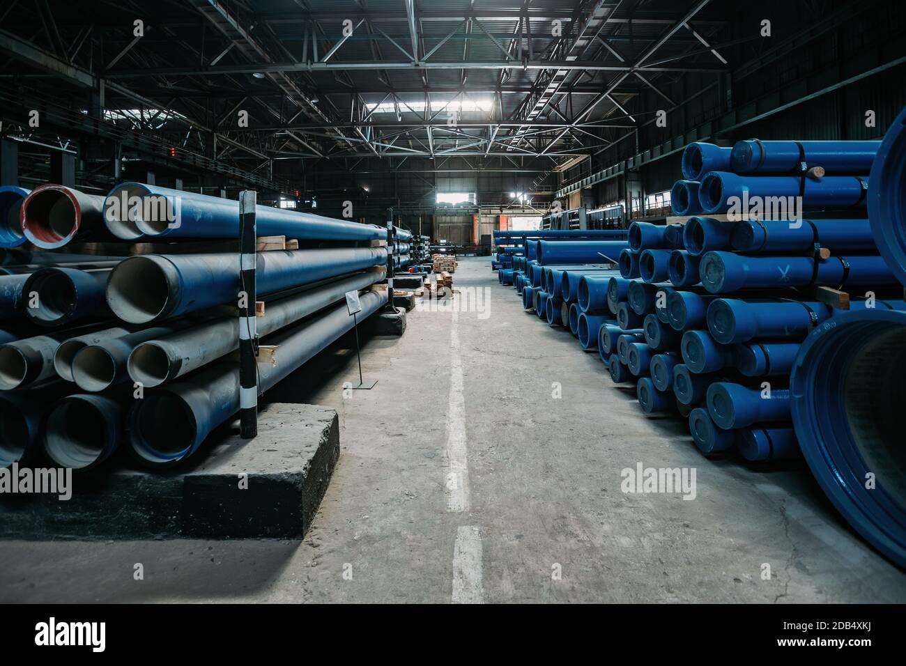 New cast iron pipes for pipeline construction in warehouse Stock Photo ...