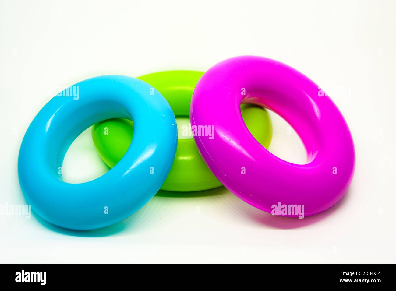 three colored plastic rings isolated on a white background. Children's ...
