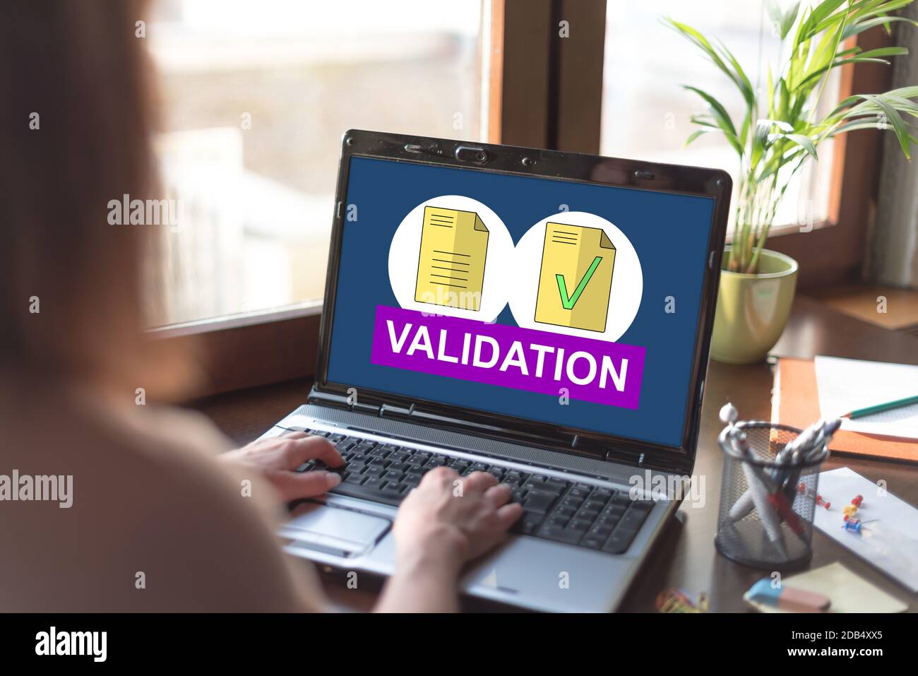 Laptop screen displaying a document validation concept Stock Photo - Alamy