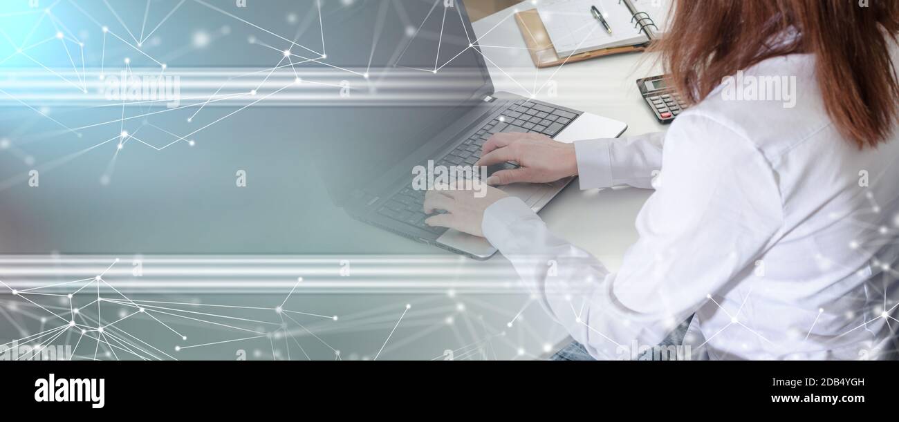Businesswoman typing on a laptop at the office; panoramic banner Stock ...