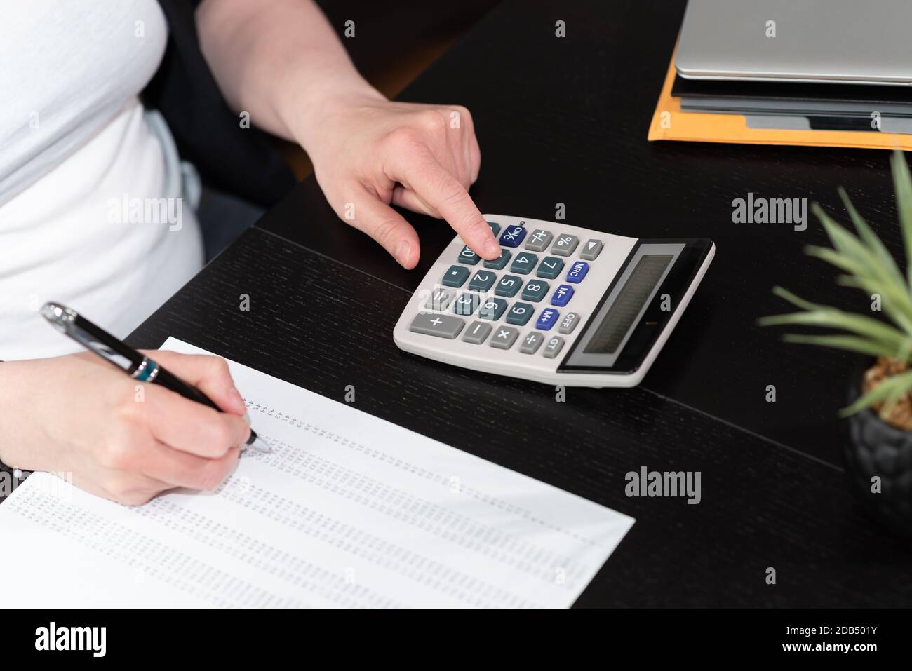 Businesswoman using calculator and working on financial data Stock ...
