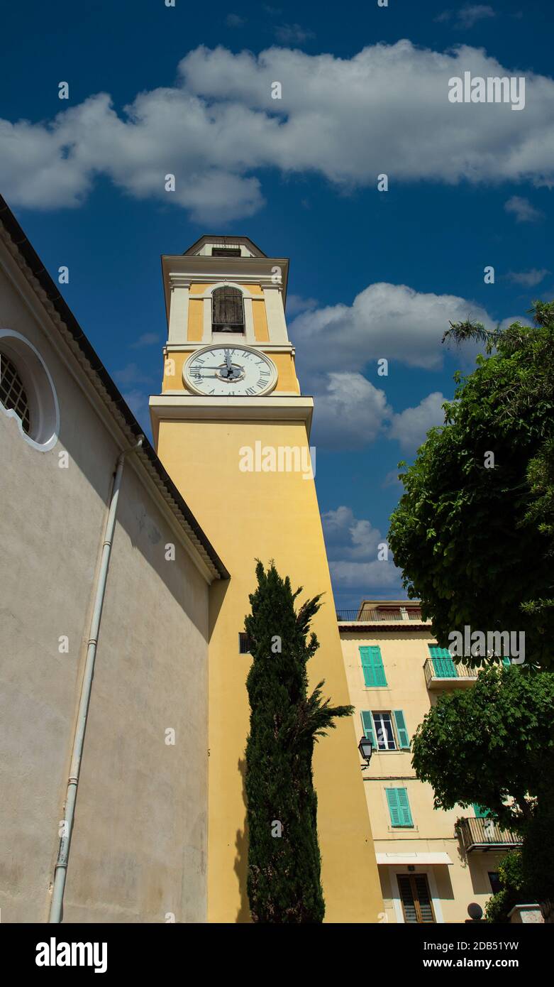 Yellow clock tower in Villefranche, France under clear blue skies Stock ...
