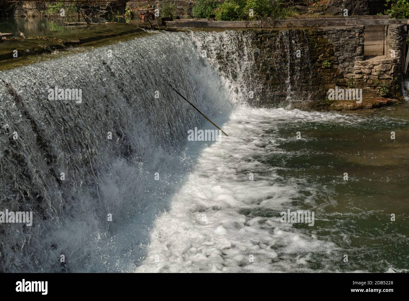 Close up of water flowing over water dam Stock Photo - Alamy