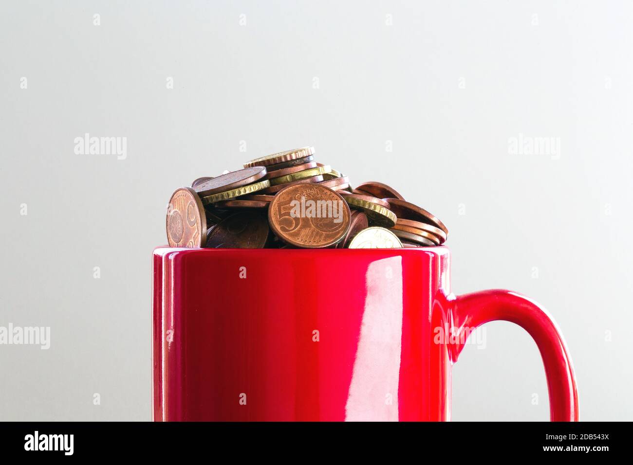 Saved Money in a colorful red mug to Finance Goals overflowing with ...