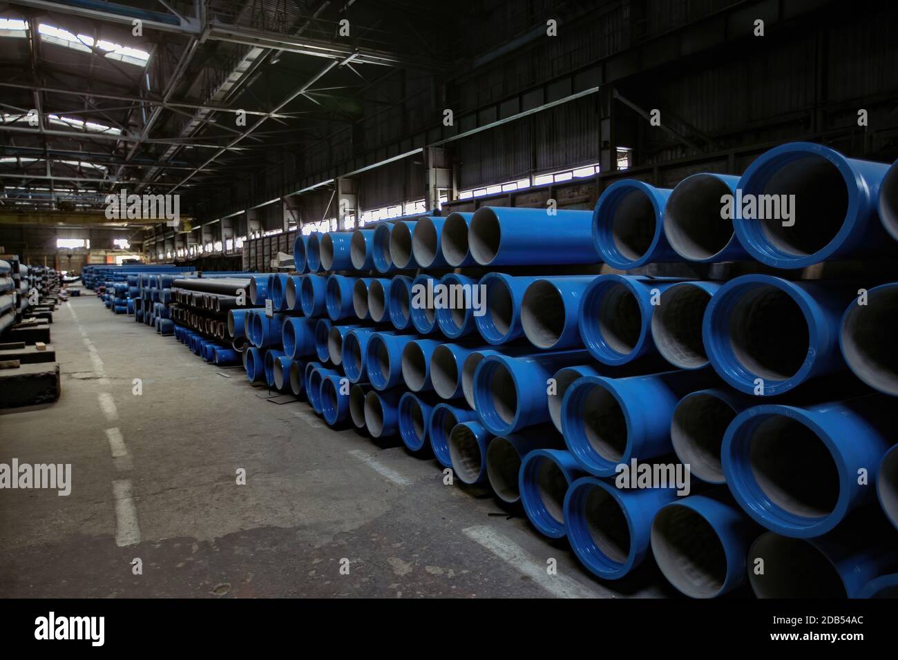 New cast iron pipes for pipeline construction in warehouse Stock Photo ...