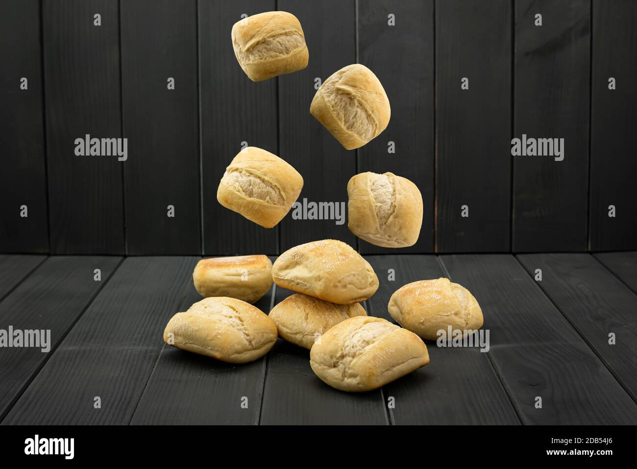 Loaf tender bread, golden and crisp, falling and stacking on a gray ...