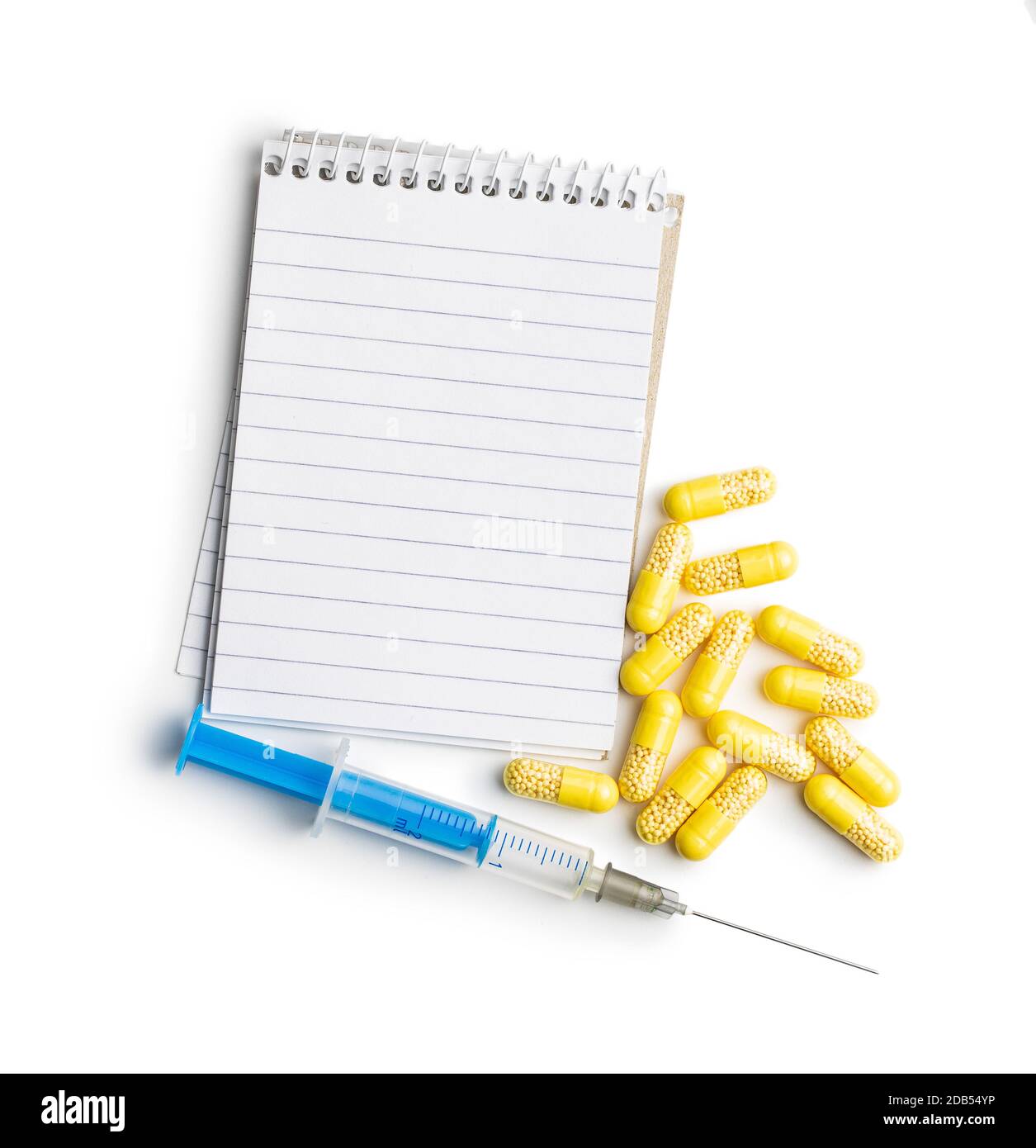 Vitamin capsules. Vitamin C pills, notebook and syringe isolated on ...