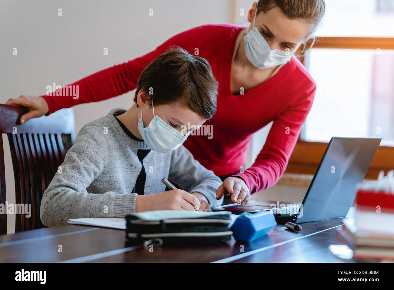 School student learning in video chat with teacher in e-learning ...