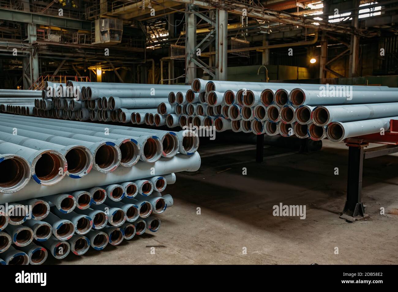 New cast iron pipes for pipeline construction in warehouse Stock Photo ...
