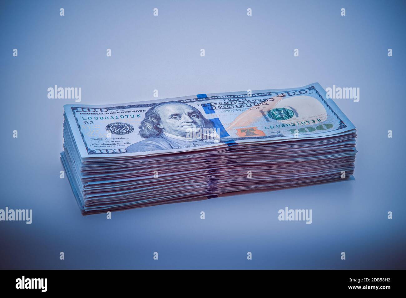 A big stack of hundred-dollar bills. Blue design. Vignetting Stock ...