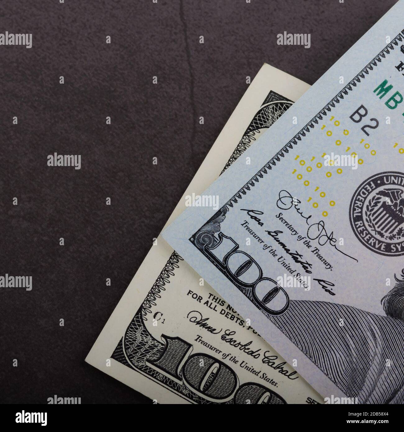 One hundred dollar bills on a gray background Stock Photo - Alamy
