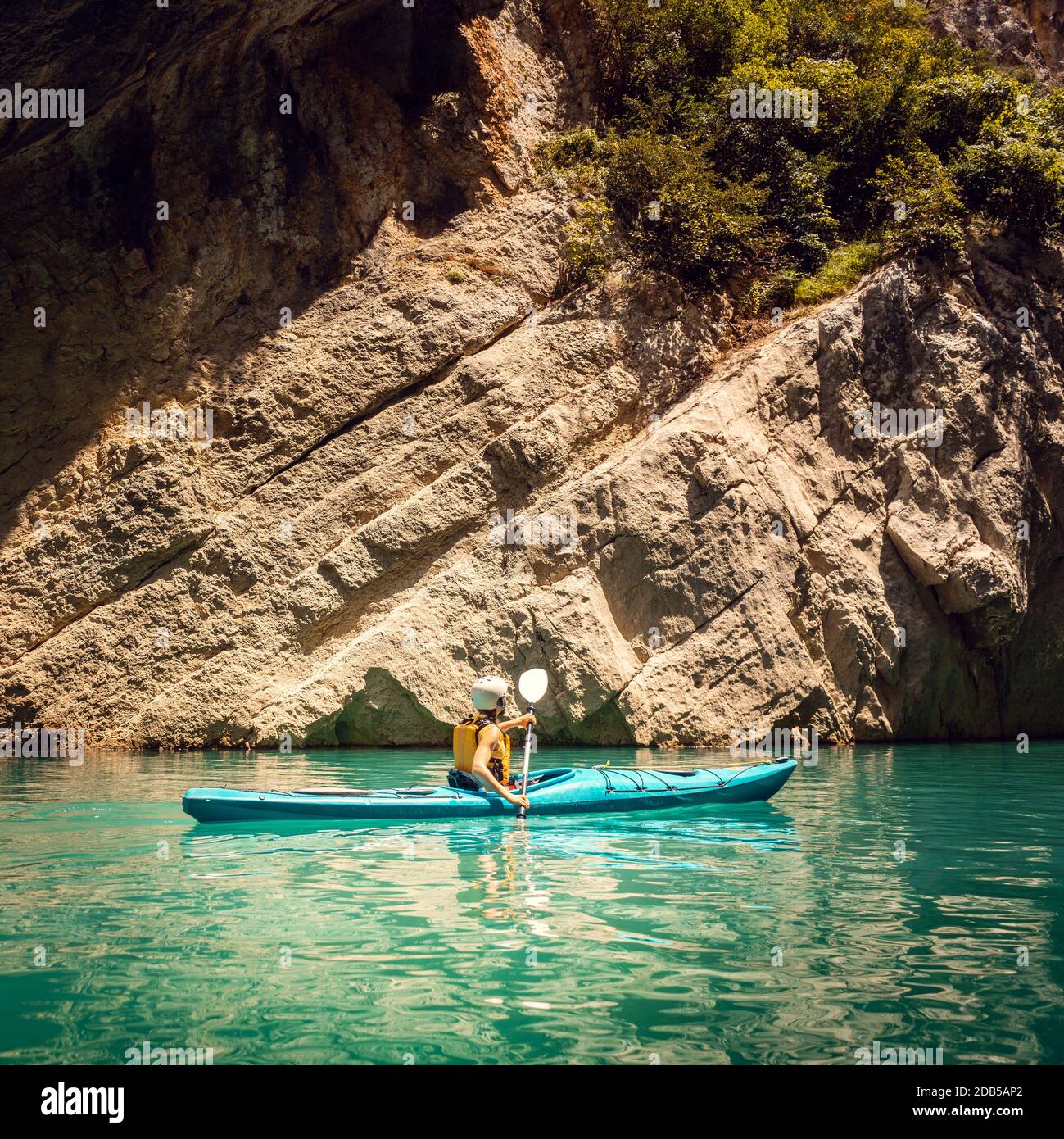 Woman on a kayak in the Pyrenees mountains in Catalonia on the waters ...