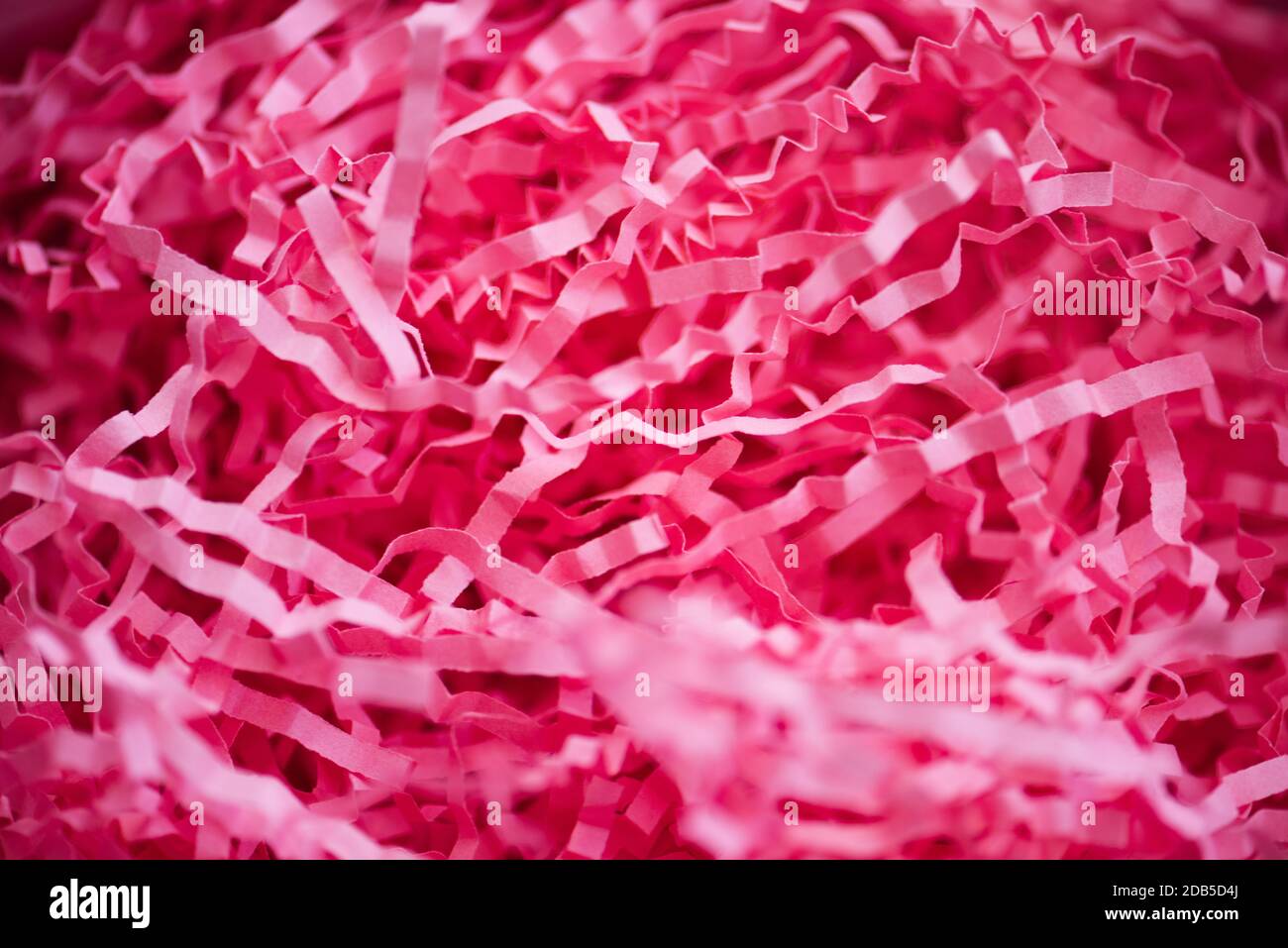 Texture of shredded pink paper packing material. Background for copy ...