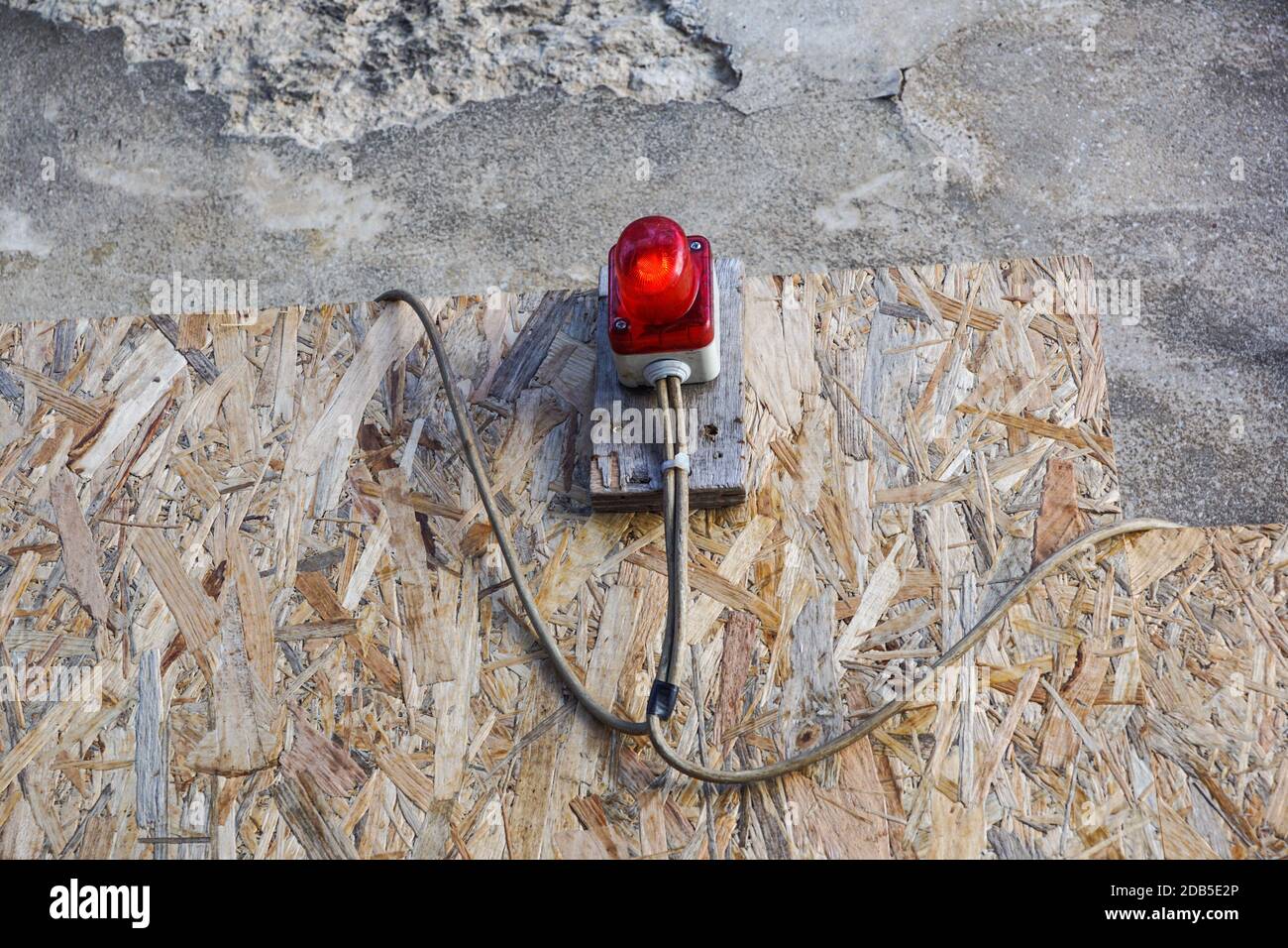bright red construction lamp lit with fence in background on entrance ...