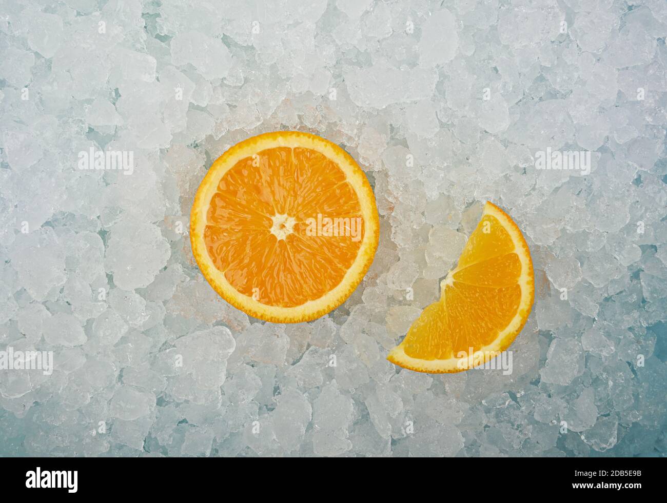 Close up one fresh juicy orange cut half and wedge slice over ...