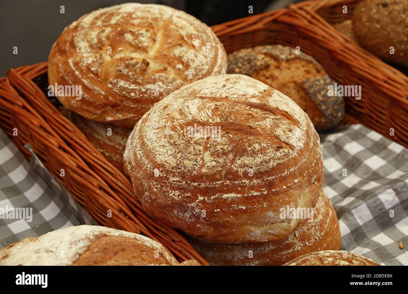 Close up selection of assorted fresh bread loaves on retail display of ...