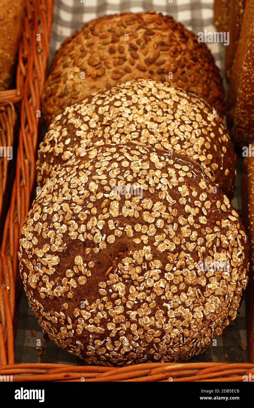 Close up selection of fresh bread loaves on retail display of bakery ...