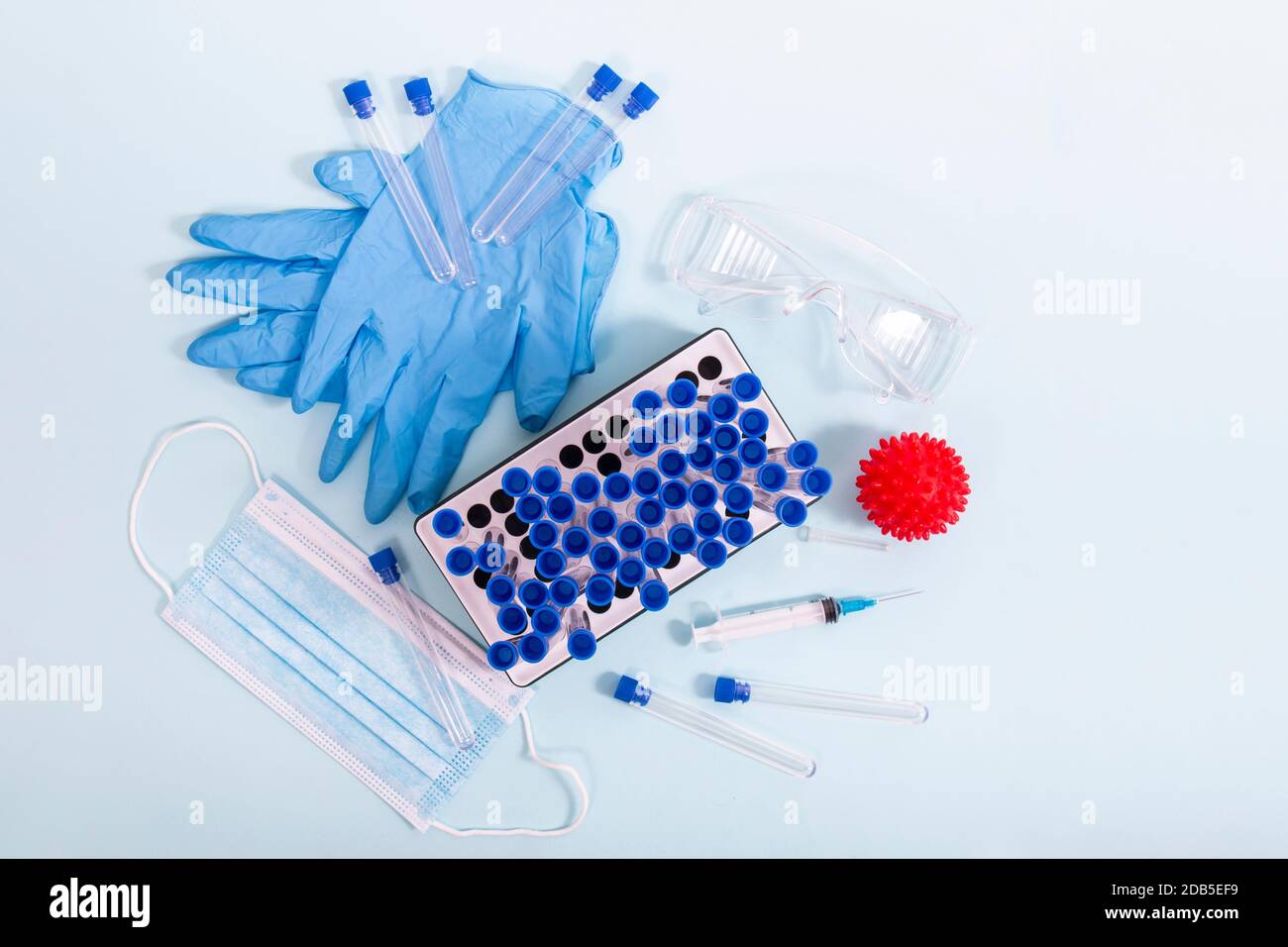 Several laboratory objects including protective mask, vial rack ...