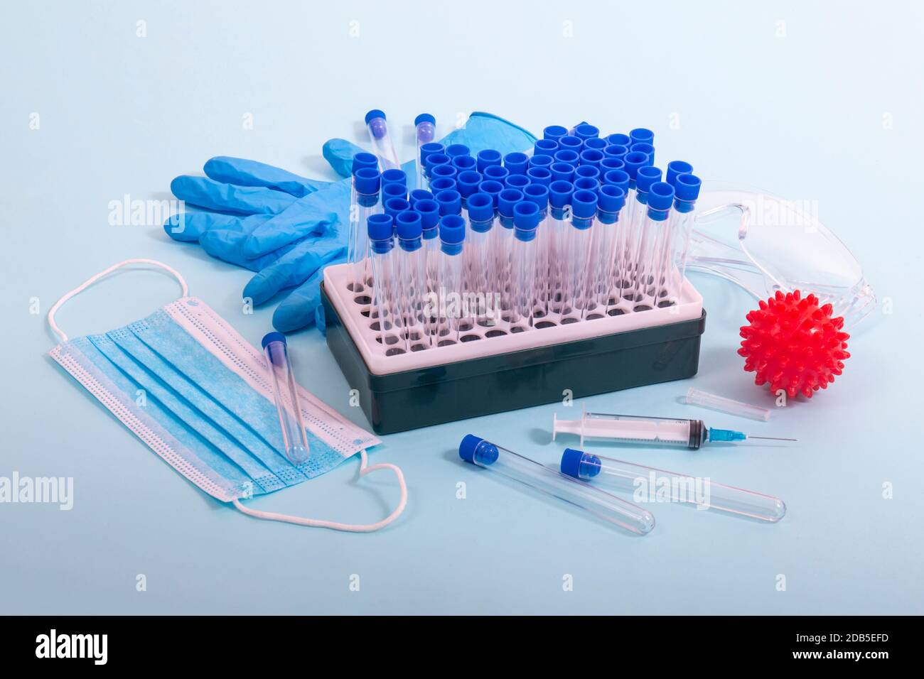 Several laboratory objects including protective mask, vial rack ...