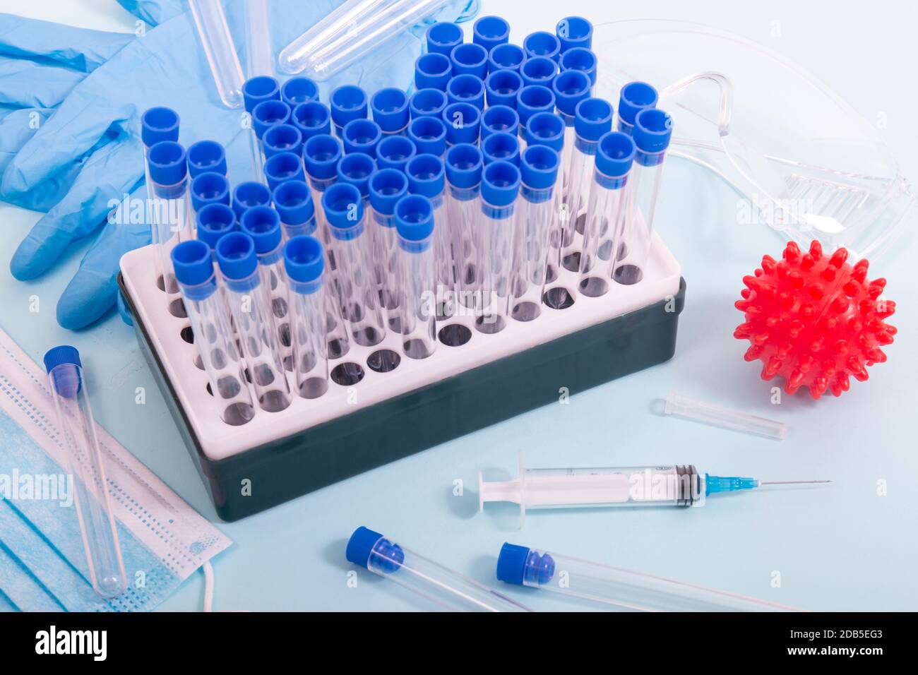 Several laboratory objects including protective mask, vial rack ...