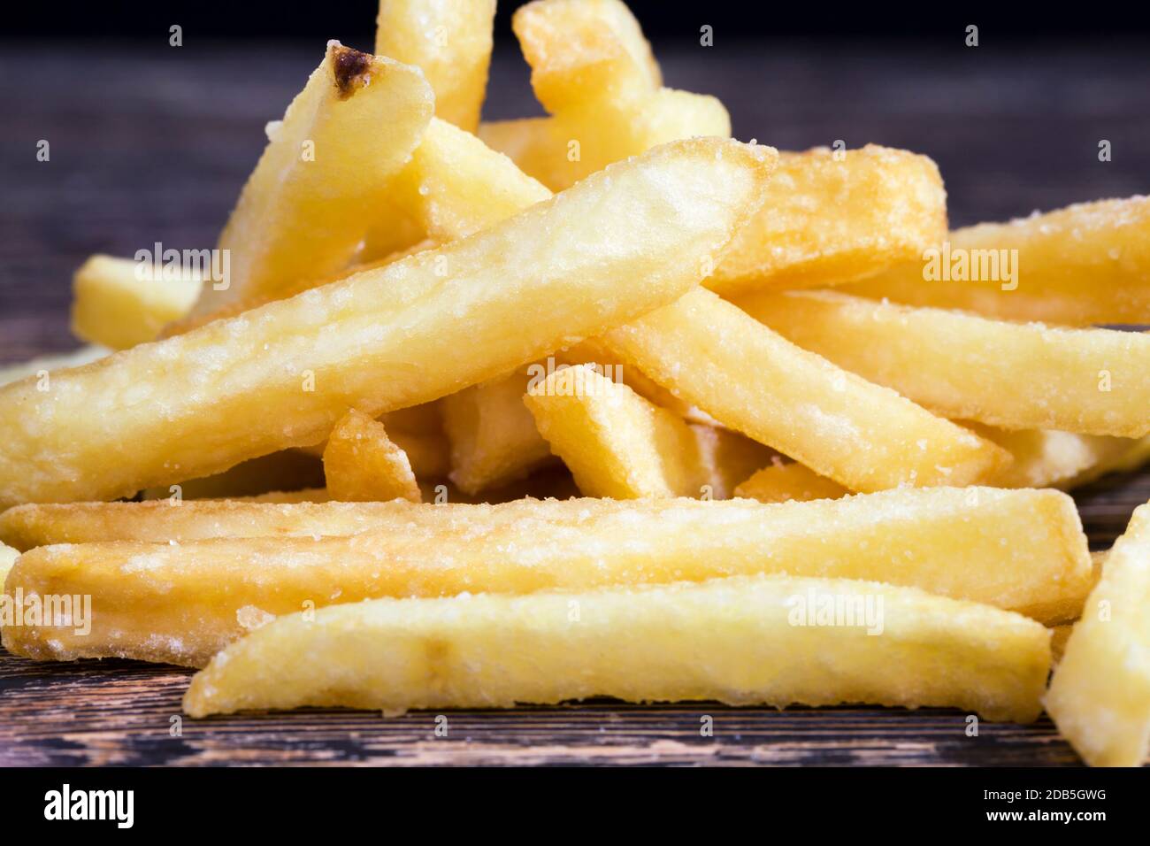 real fries on wooden table, details and close-up of food made in oil ...