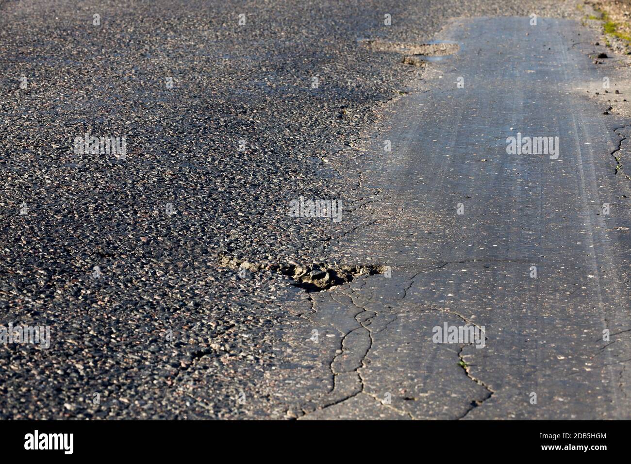 old tainted asphalt road with permanent damage and poor quality Stock ...